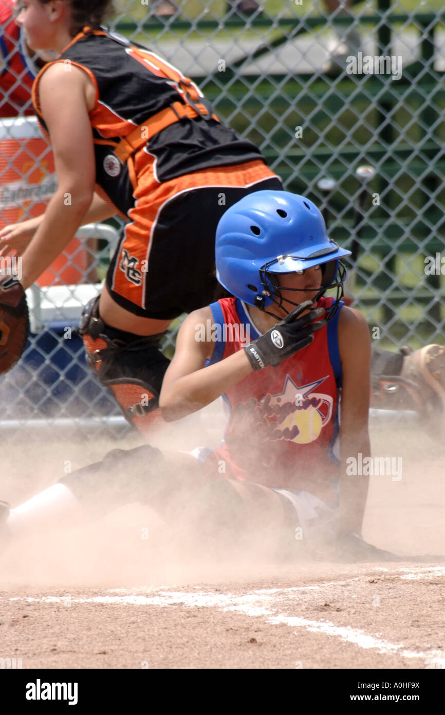 Teenage female Major league Softball action - dust from sliding to the ...