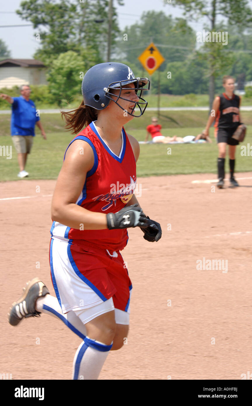 Teenage girl playing in a major league Softball game Stock Photo - Alamy