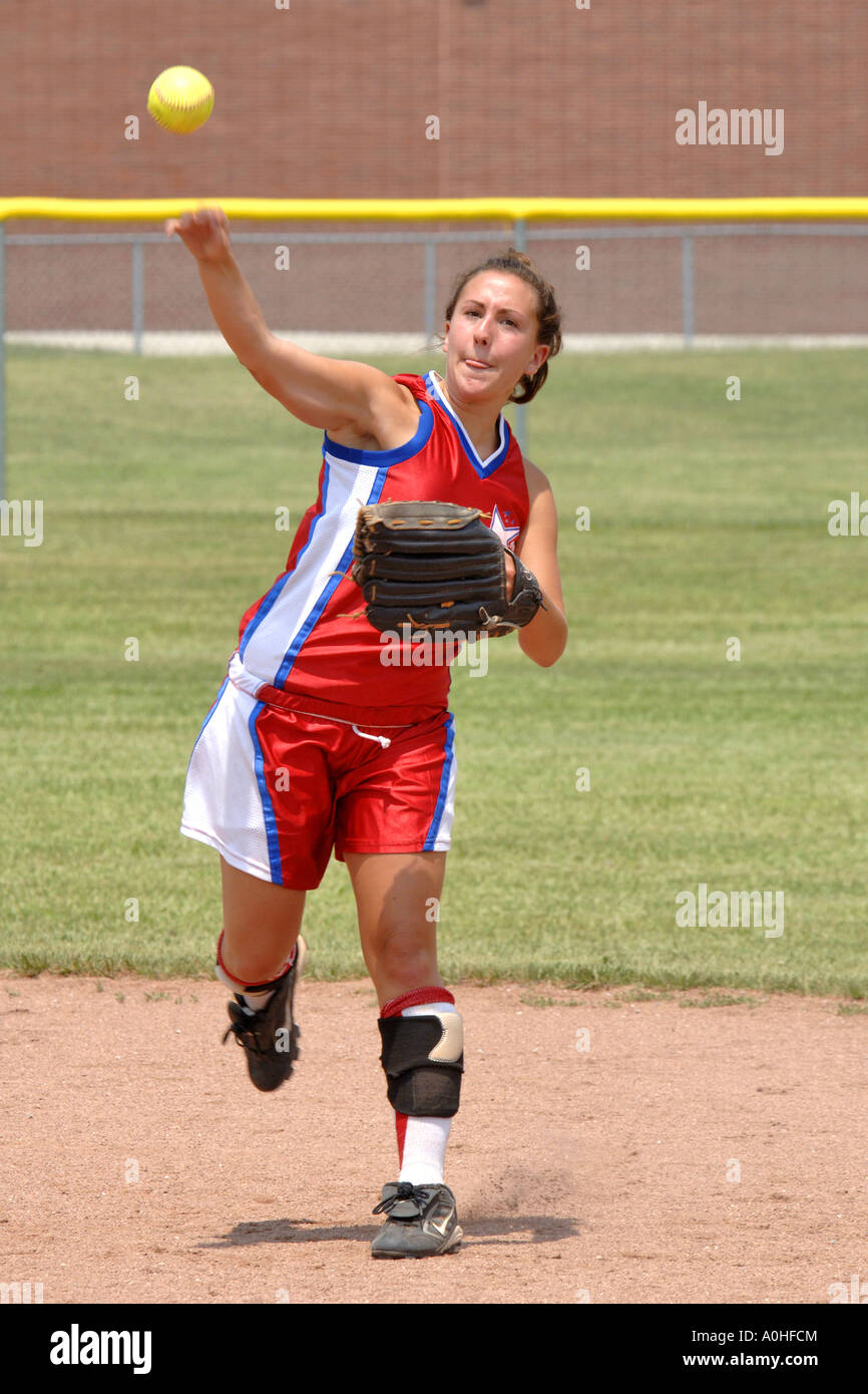 Teenage girl playing in a major league Softball game Stock Photo - Alamy