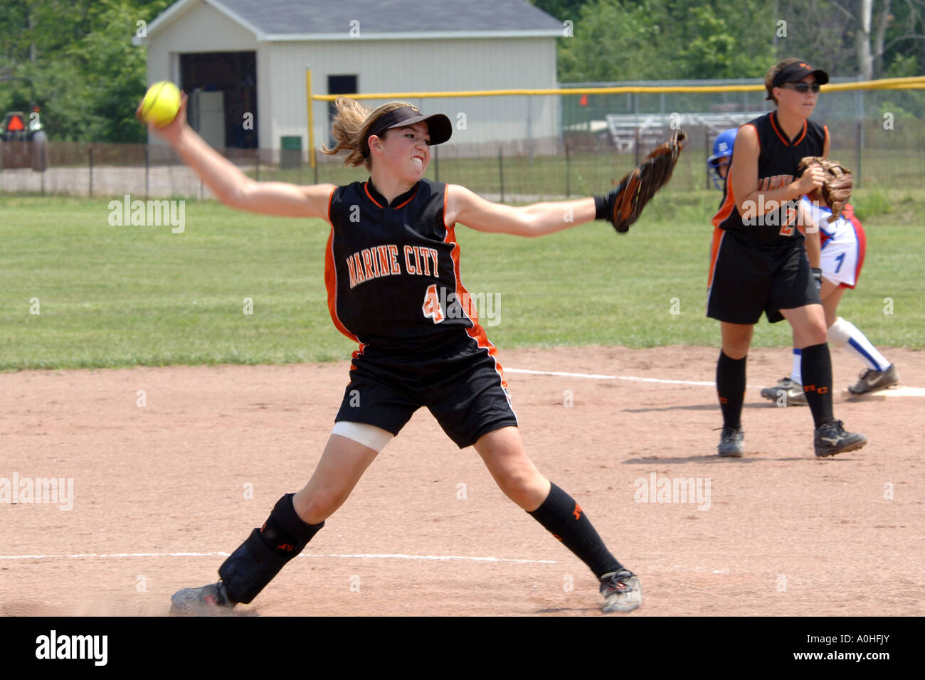 Teenage female Major league Softball action Stock Photo - Alamy