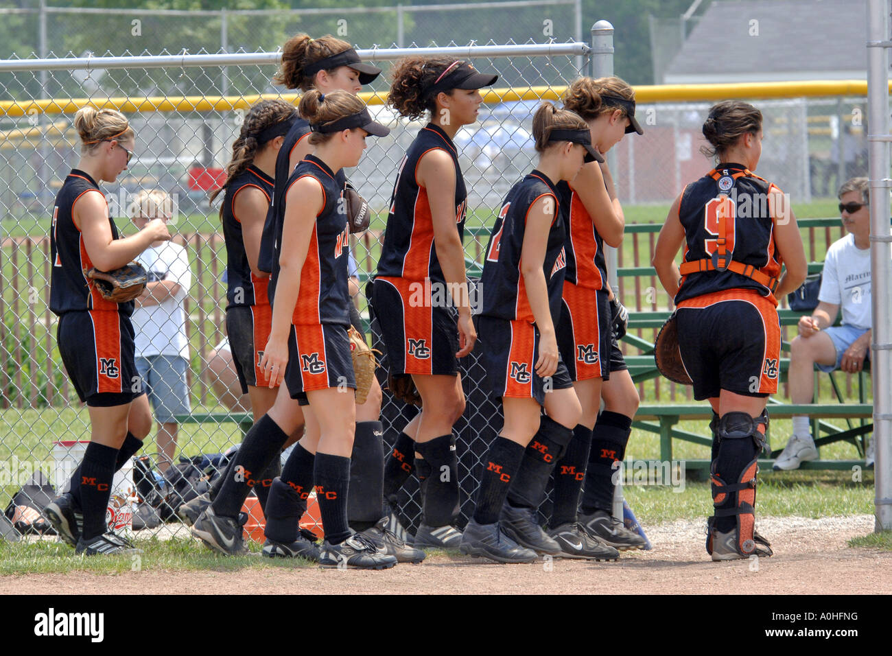 Teenage female major league Softball players sitting on the bench Stock ...