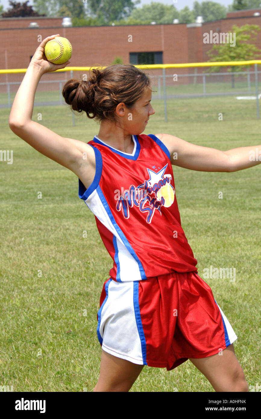 Teenage girl playing in a major league Softball throwing the ball Stock ...