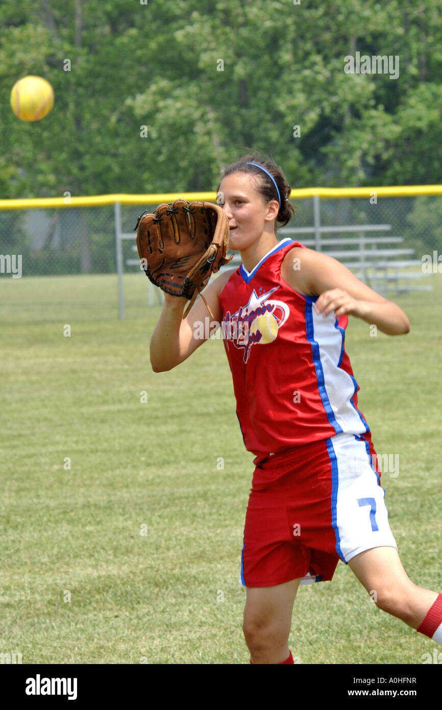 Teenage girl playing in a major league Softball game practicing with a ...