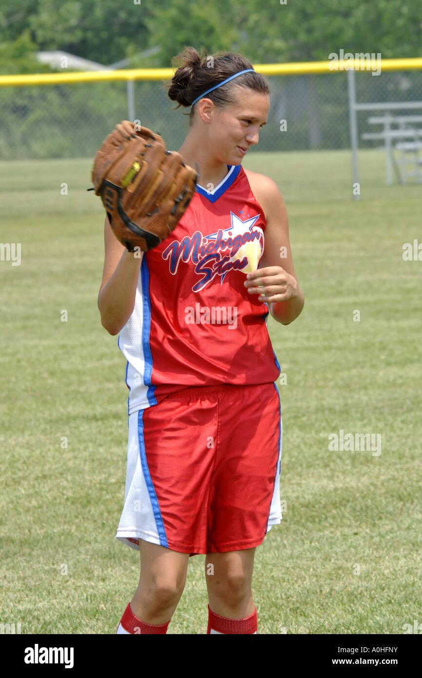 Teenage girl playing in a major league Softball game practicing with a ...