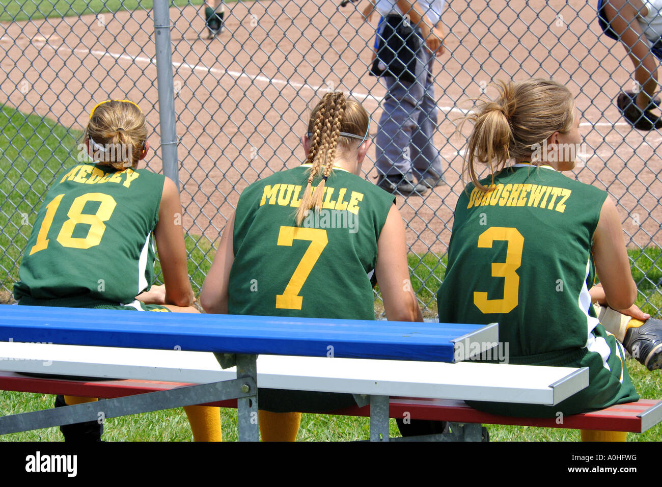 Teenage female major league Softball players sitting on the bench Stock ...