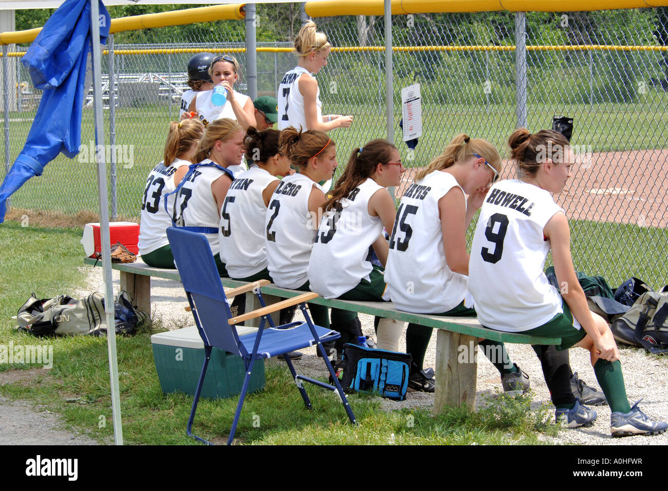 Teenage female major league Softball players sitting on the bench Stock ...