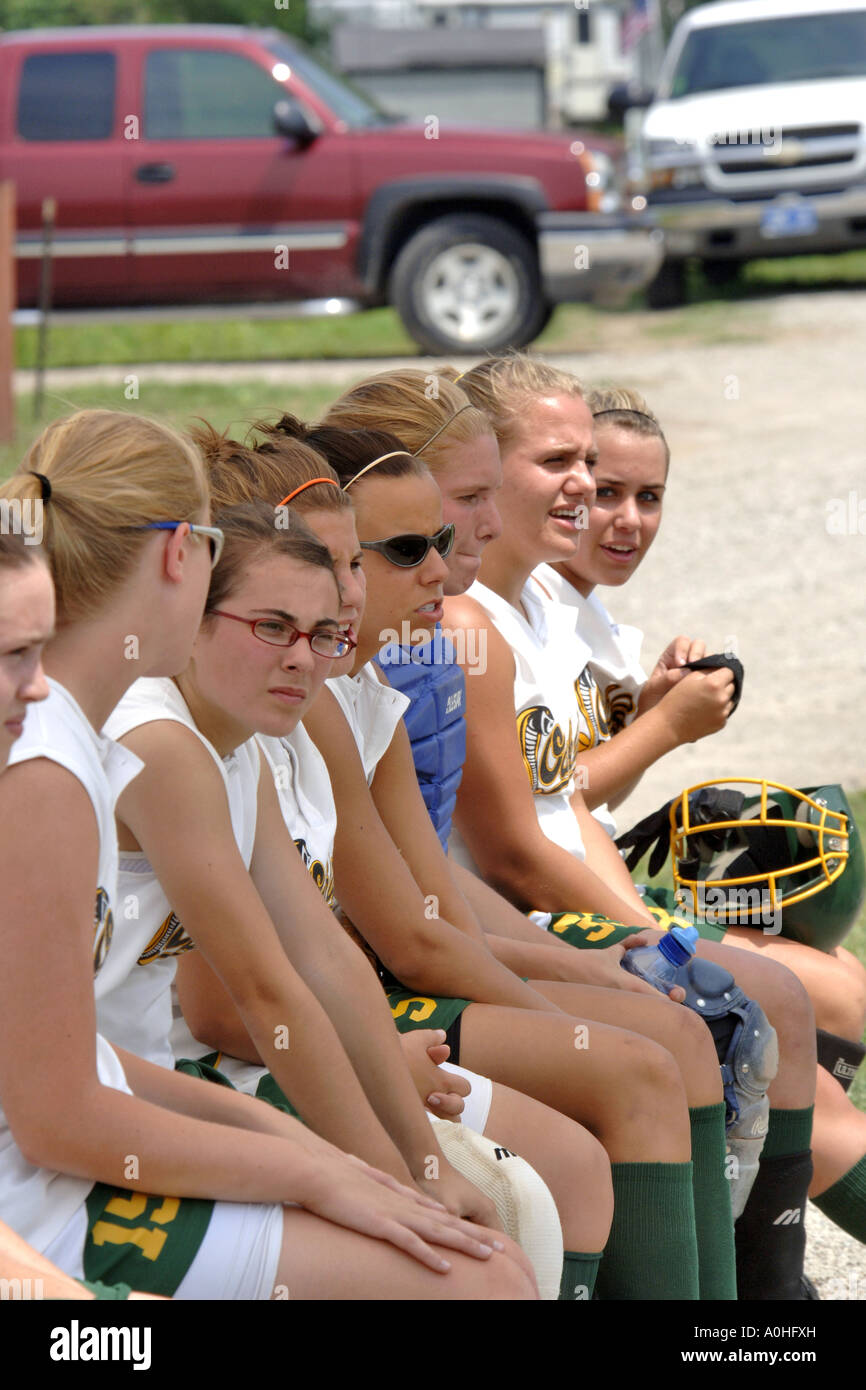 Teenage female major league Softball players sitting on the bench Stock ...
