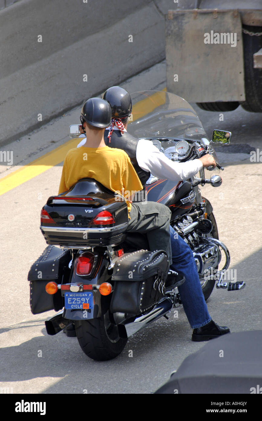 Harley Davidson motorcycle in a traffic jam, the riders inhaling ...