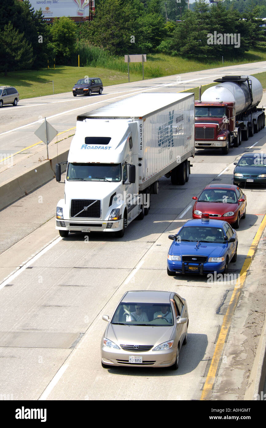 Semi Trucks and cars on a US Highway at the weekend Stock Photo - Alamy