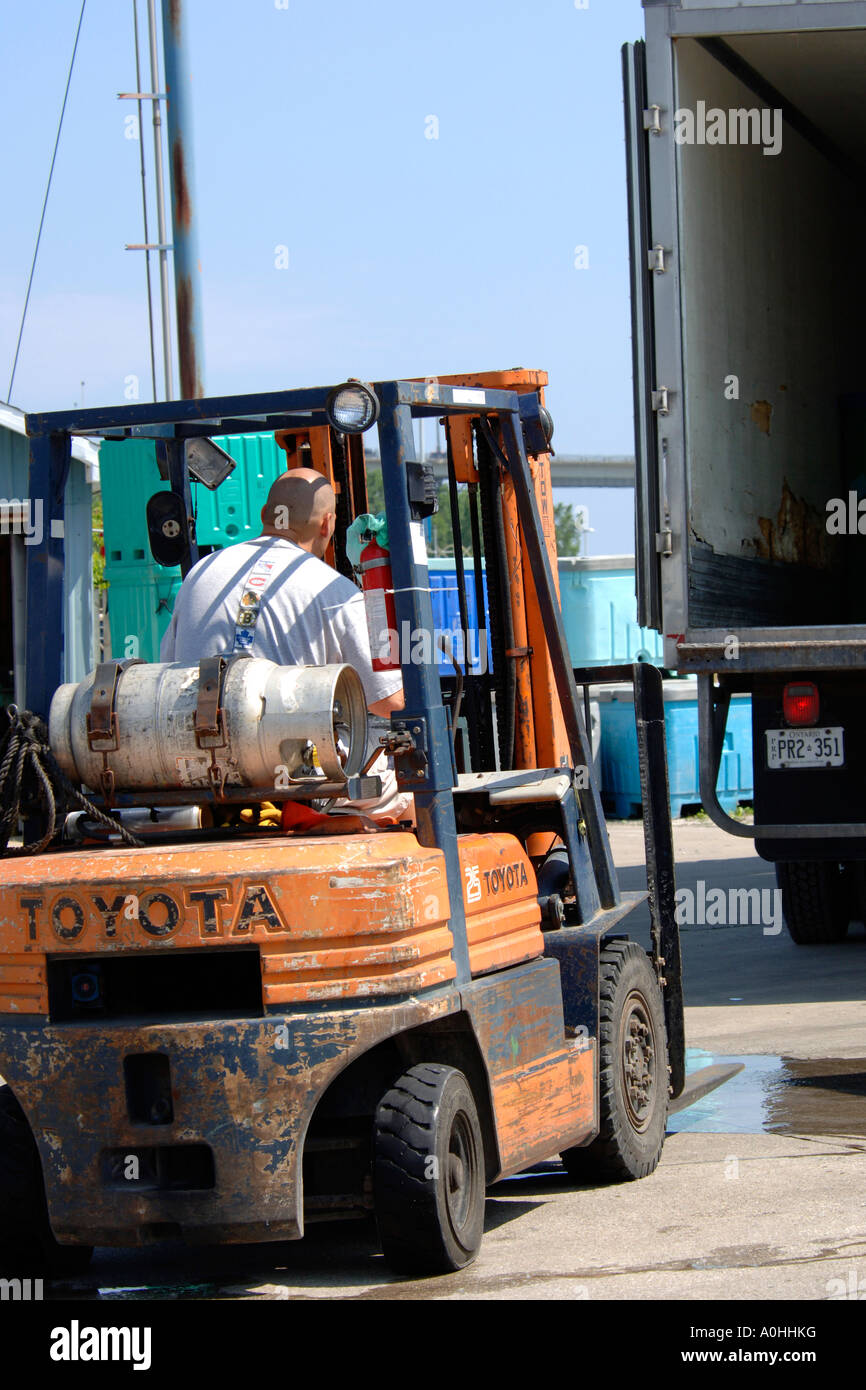 A Forklift truck moving cargo around a factory loading bay in Michigan ...