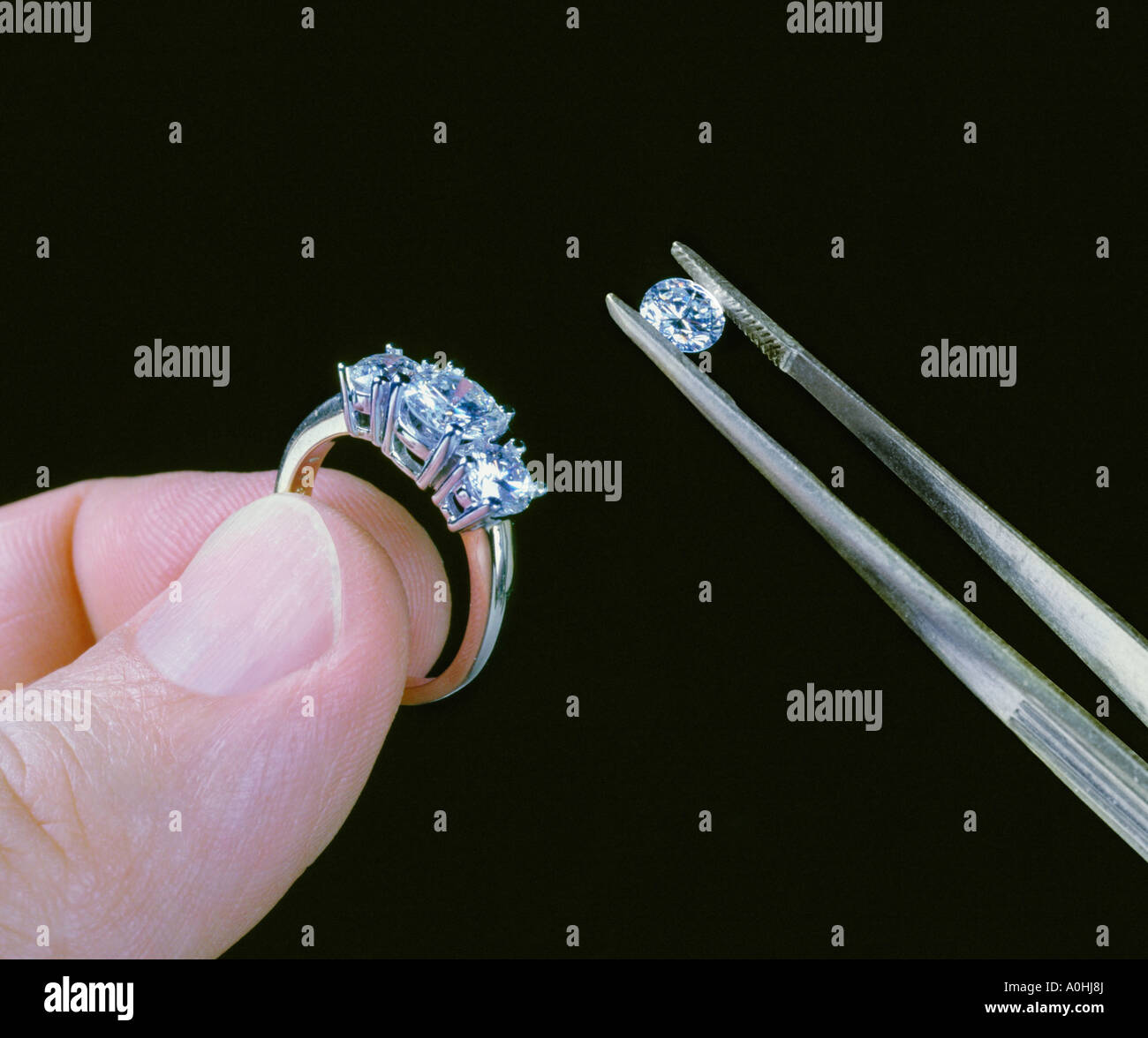 hand holding diamond ring and stone with tweezers Stock Photo - Alamy