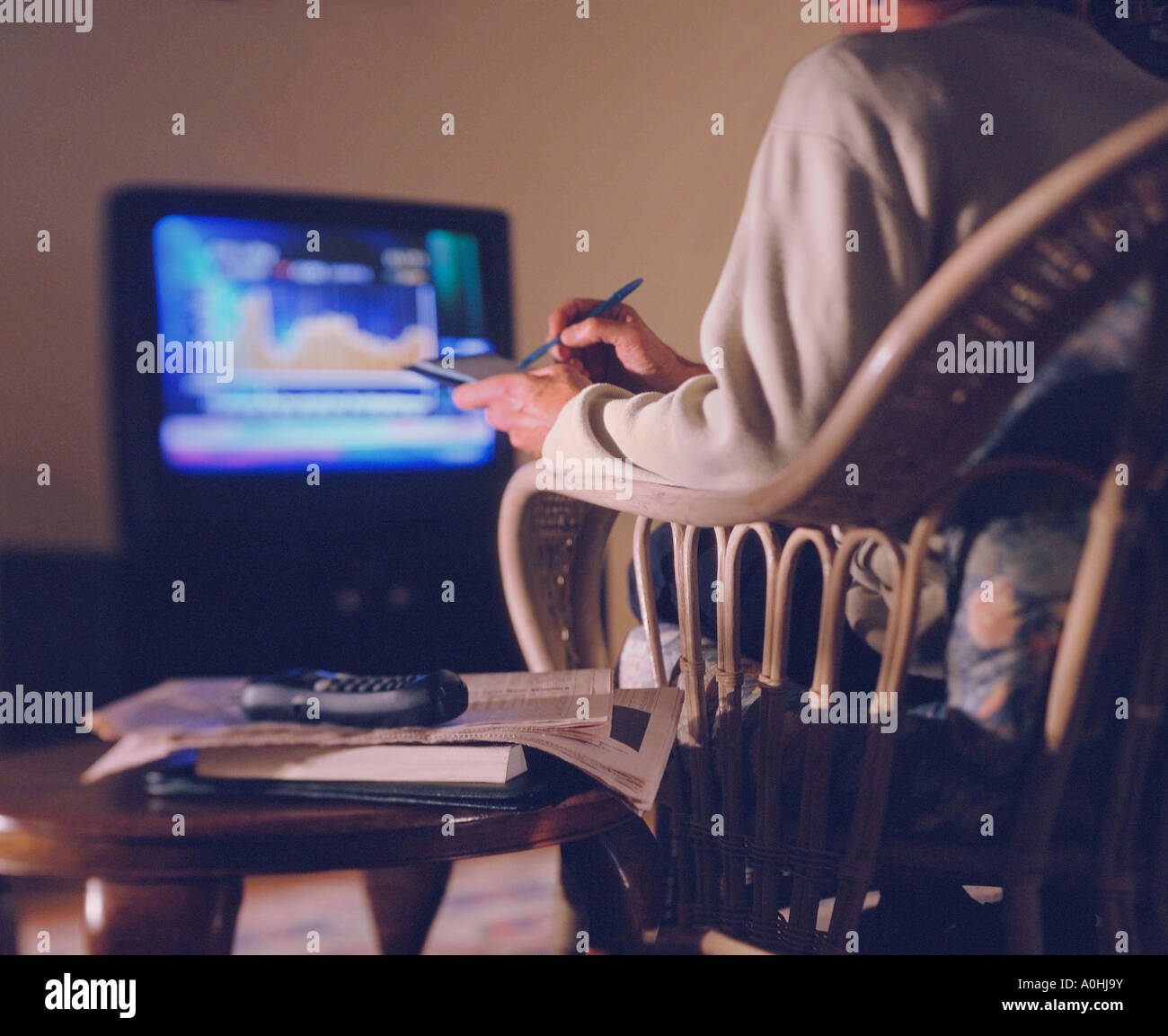 man watching stock market analysis on television Stock Photo - Alamy