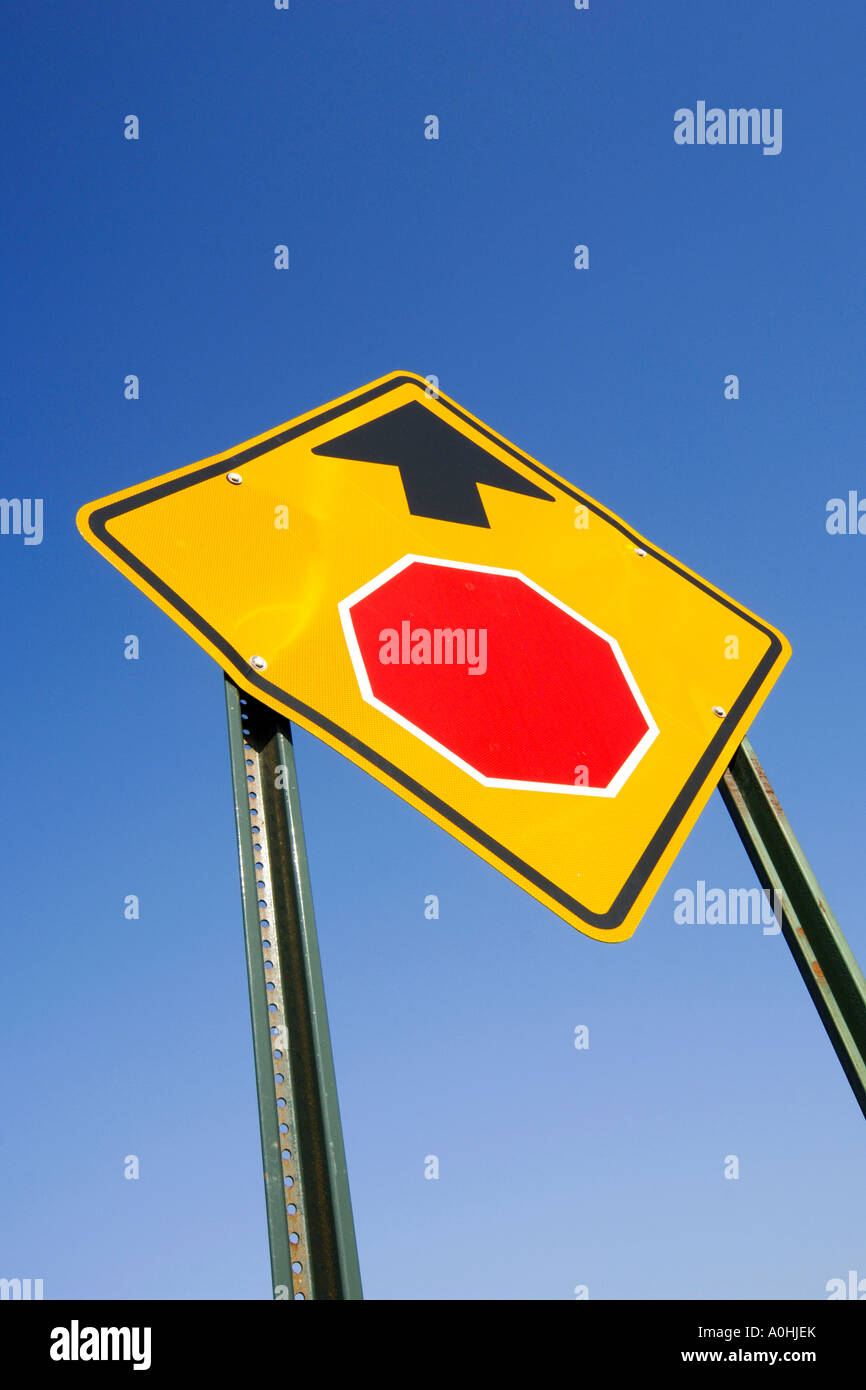 Yellow Stop sign with an arrow Stock Photo - Alamy