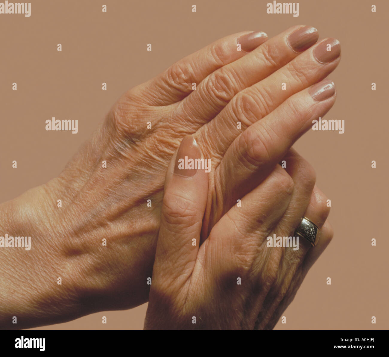 senior woman rubbing hands in apparent pain Stock Photo - Alamy
