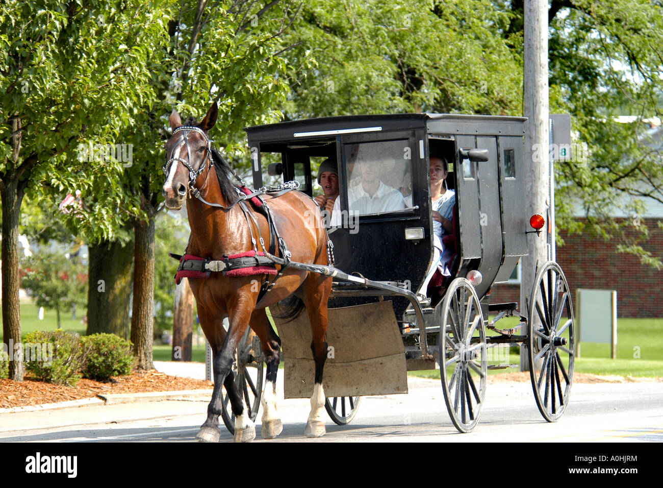 Amish horse drawn buggy on the highway in Shipshewana, Indiana Stock ...