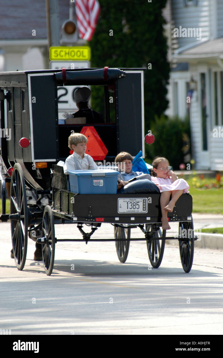 Amish children in the back trailer of a horse and buggy combo in ...