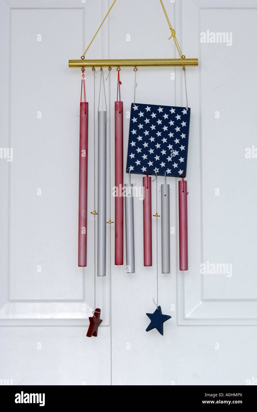 American flag wind chimes hanging on a white fron door on July 4th ...
