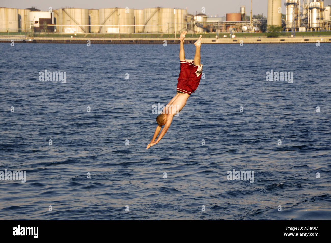 Teenage male pier diving into the St Clair River at Port Huron Michigan ...