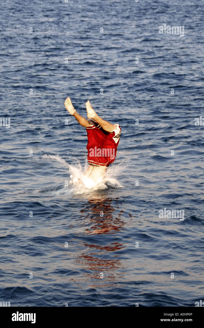 Teenage male pier diving into the St Clair River at Port Huron Michigan ...