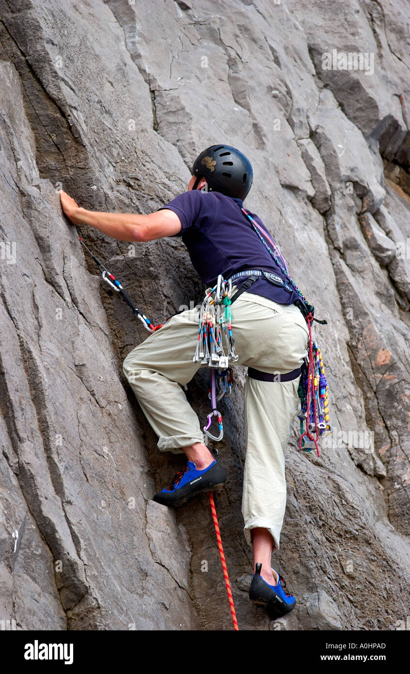 Rock climbing Three Cliff Bay on the Gower peninsula Stock Photo - Alamy
