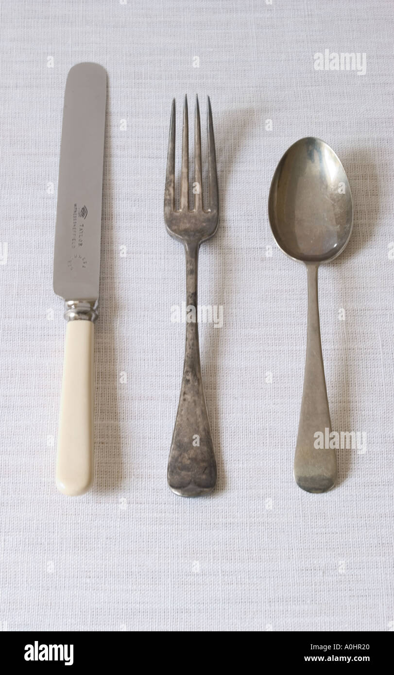 Vintage cutlery on a white linen table cloth Stock Photo - Alamy