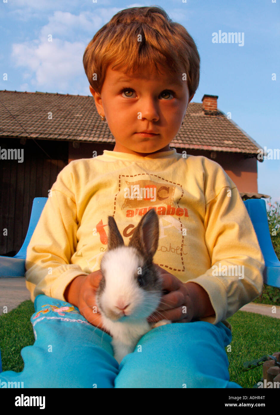 Girl holding rabbit Stock Photo - Alamy