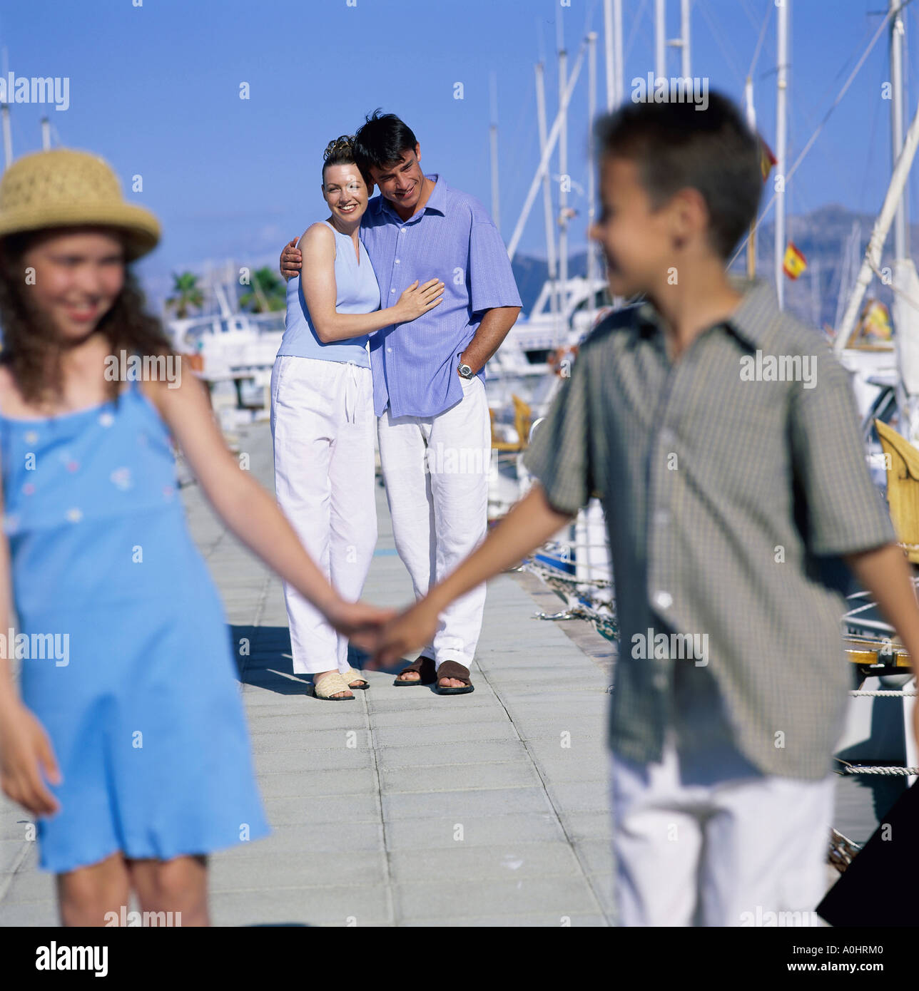 Family strolling along pier Stock Photo - Alamy