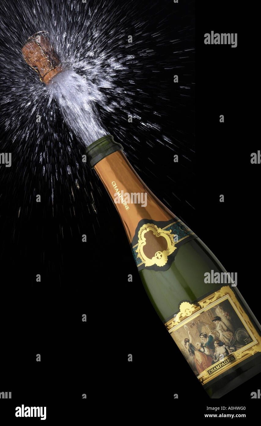 Cork popping out of champagne bottle Stock Photo - Alamy