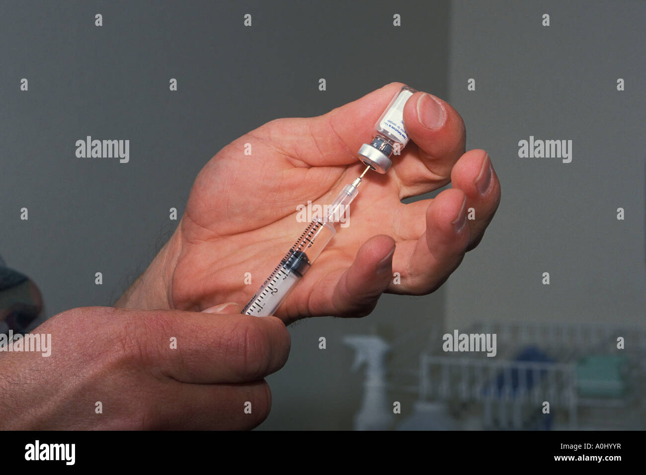 Veterinarian loading medicine into syringe from vial Stock Photo - Alamy