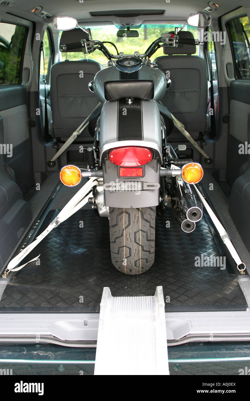 Motorcycle transport with car, secured with straps Stock Photo - Alamy