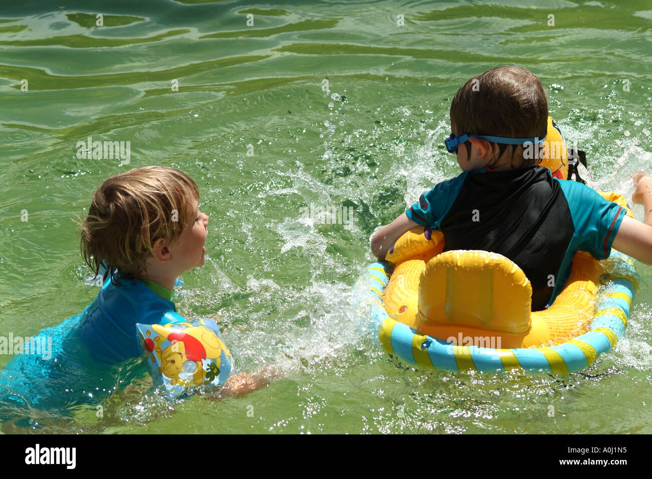 Youngster floating in pool hi-res stock photography and images - Alamy