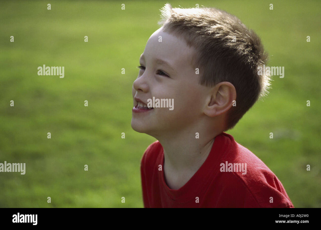 Side profile of a boy smiling Stock Photo - Alamy
