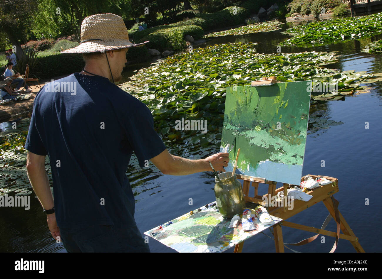 Rear view of a young man painting with a paintbrush Stock Photo - Alamy