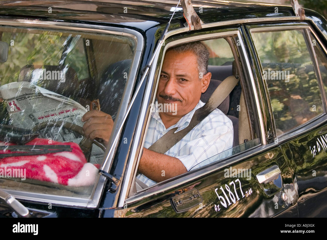 Egyptian taxi driver sitting in taxi Stock Photo - Alamy