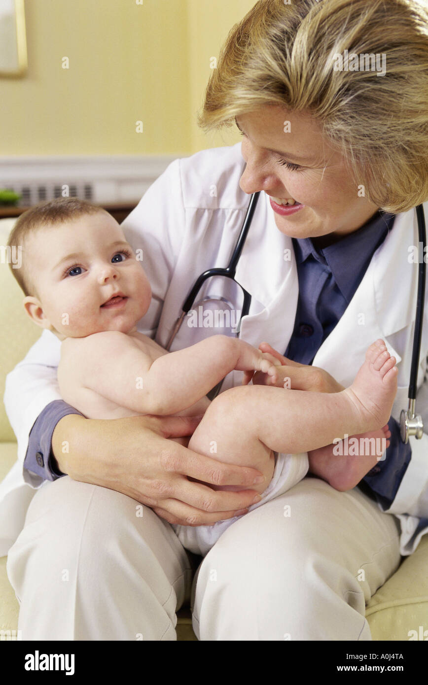 Female doctor holding a baby boy Stock Photo - Alamy