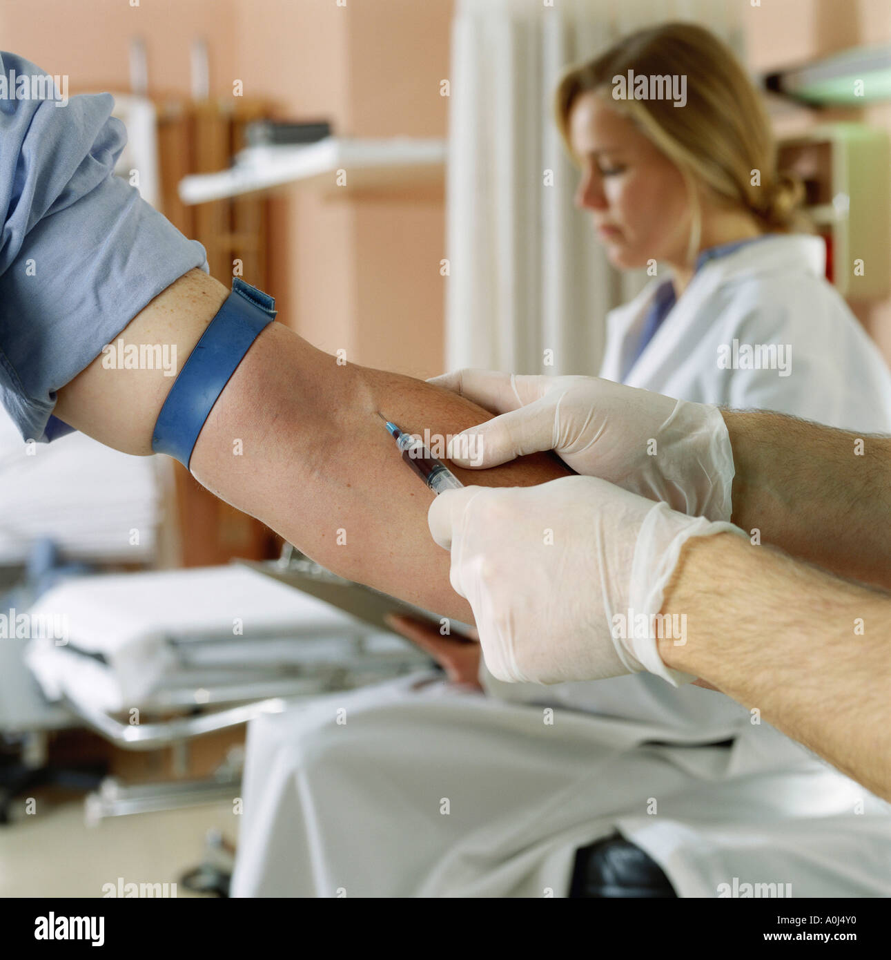 Male doctor taking a blood sample Stock Photo - Alamy