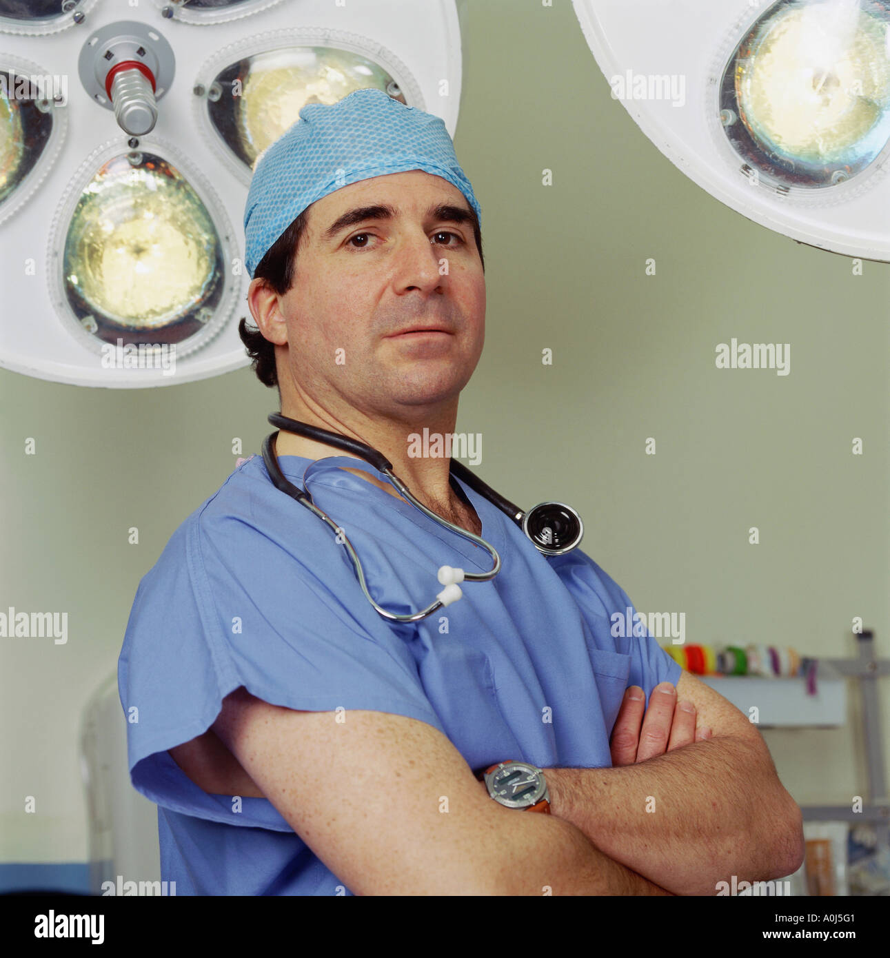 Portrait of a male surgeon standing with his arms folded Stock Photo ...