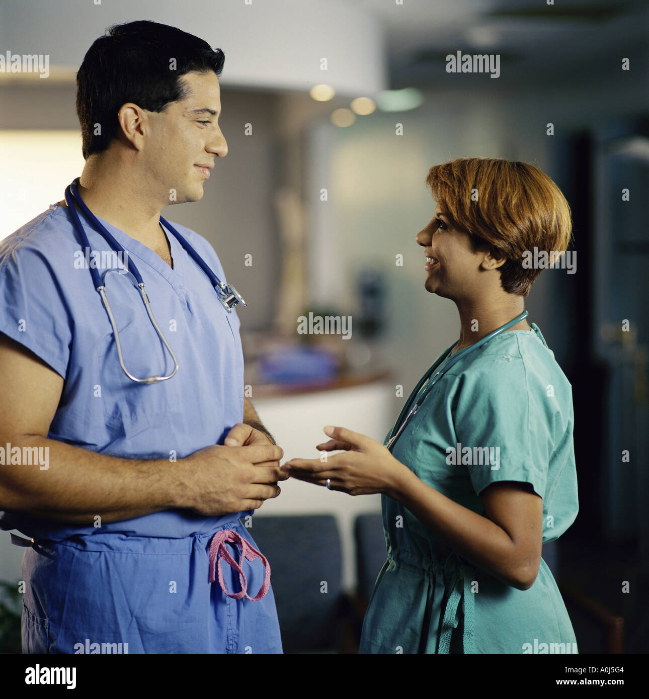 Two doctors talking face to face Stock Photo - Alamy