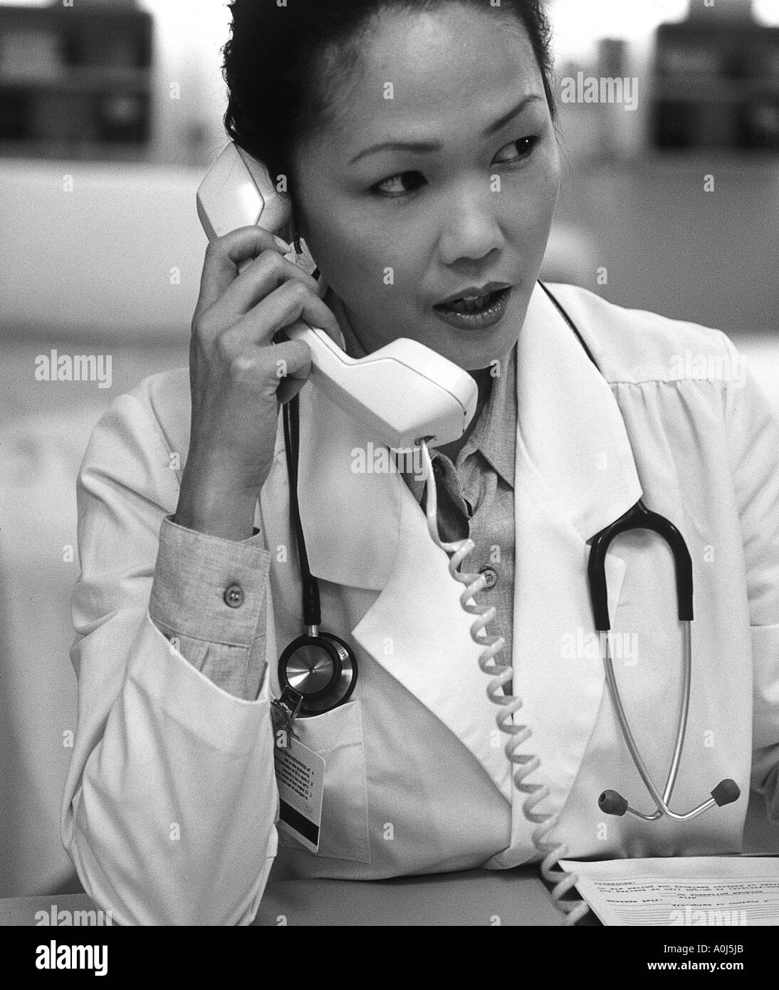 Female doctor talking on a telephone Stock Photo - Alamy
