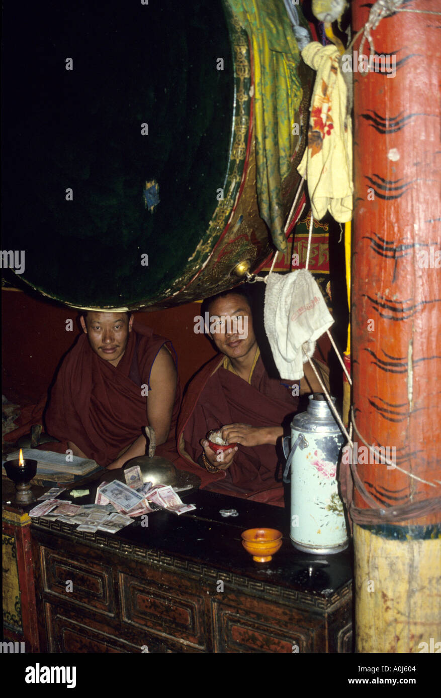 Two Buddhist monks sitting in a monastery in Tibet,China Stock Photo ...