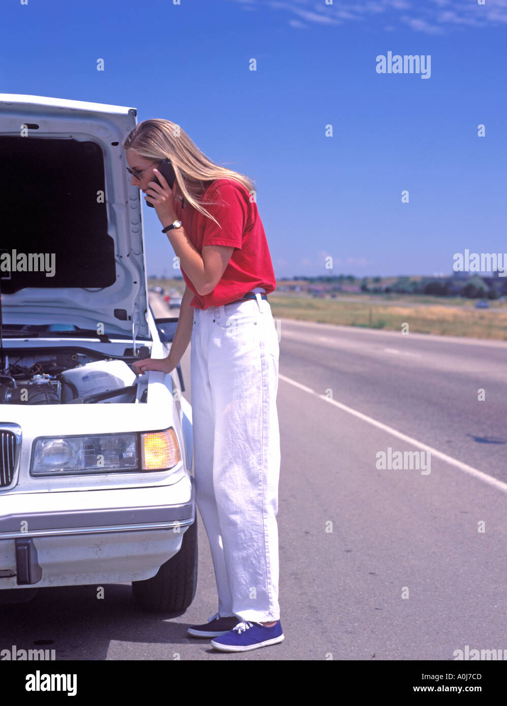 woman looking under the hood of her car Stock Photo - Alamy