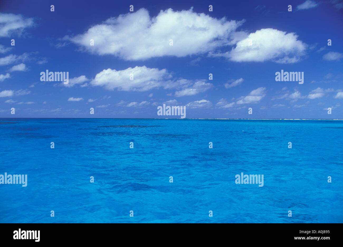 Ocean water sky and white puffy clouds Tanapag Lagoon Saipan Northern ...