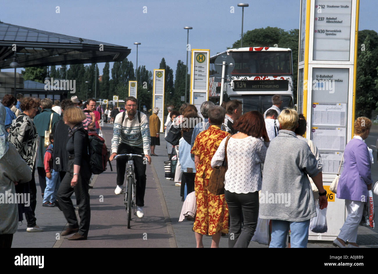 Berlin cyclist and crowded bus stop Stock Photo - Alamy