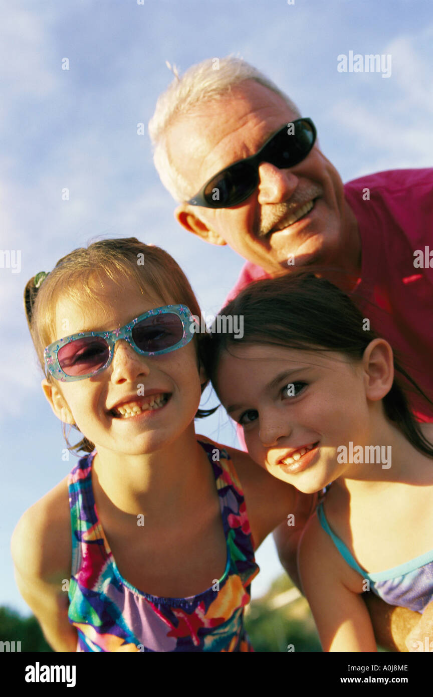 Grandfather posing with granddaughters Stock Photo - Alamy