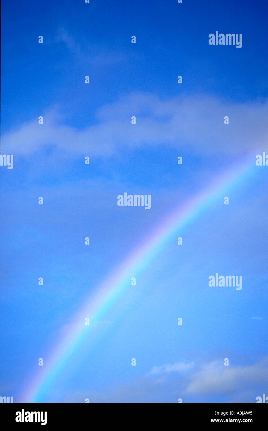 colorful rainbow appearing in blue skies Stock Photo - Alamy
