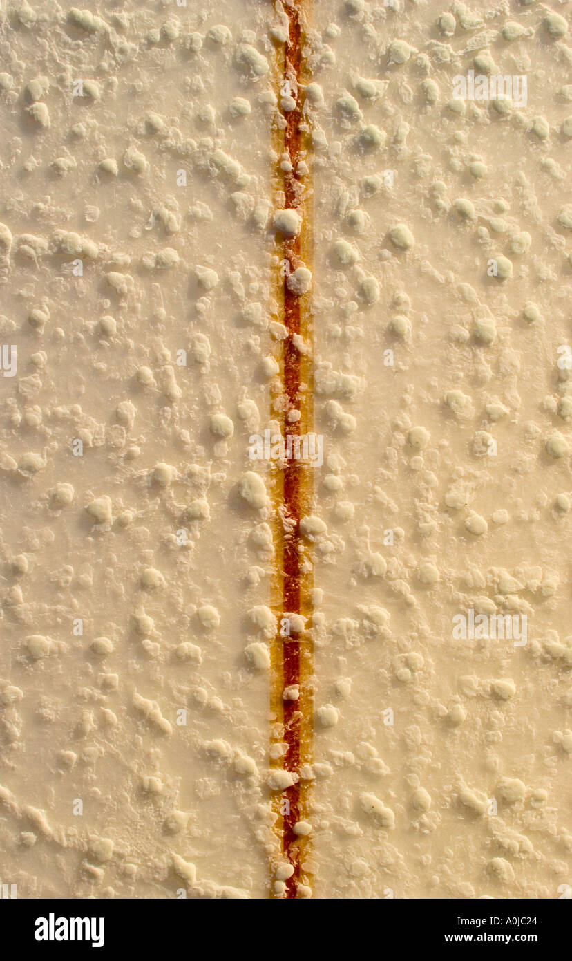 A close-up photograph of wax on a surfboard deck reveals intricate ...