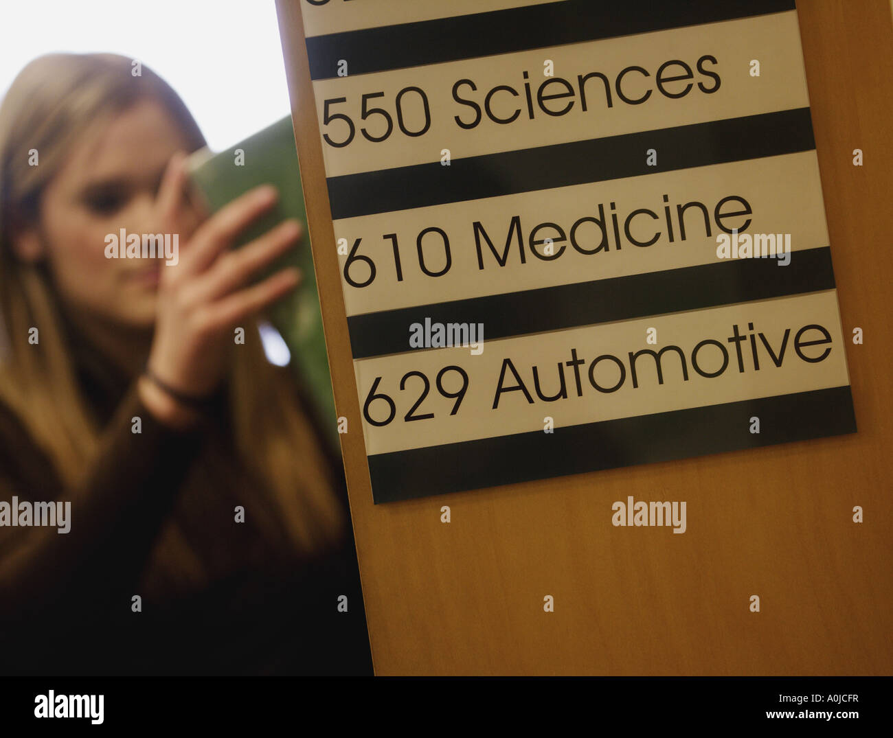 Woman finding a book Stock Photo - Alamy