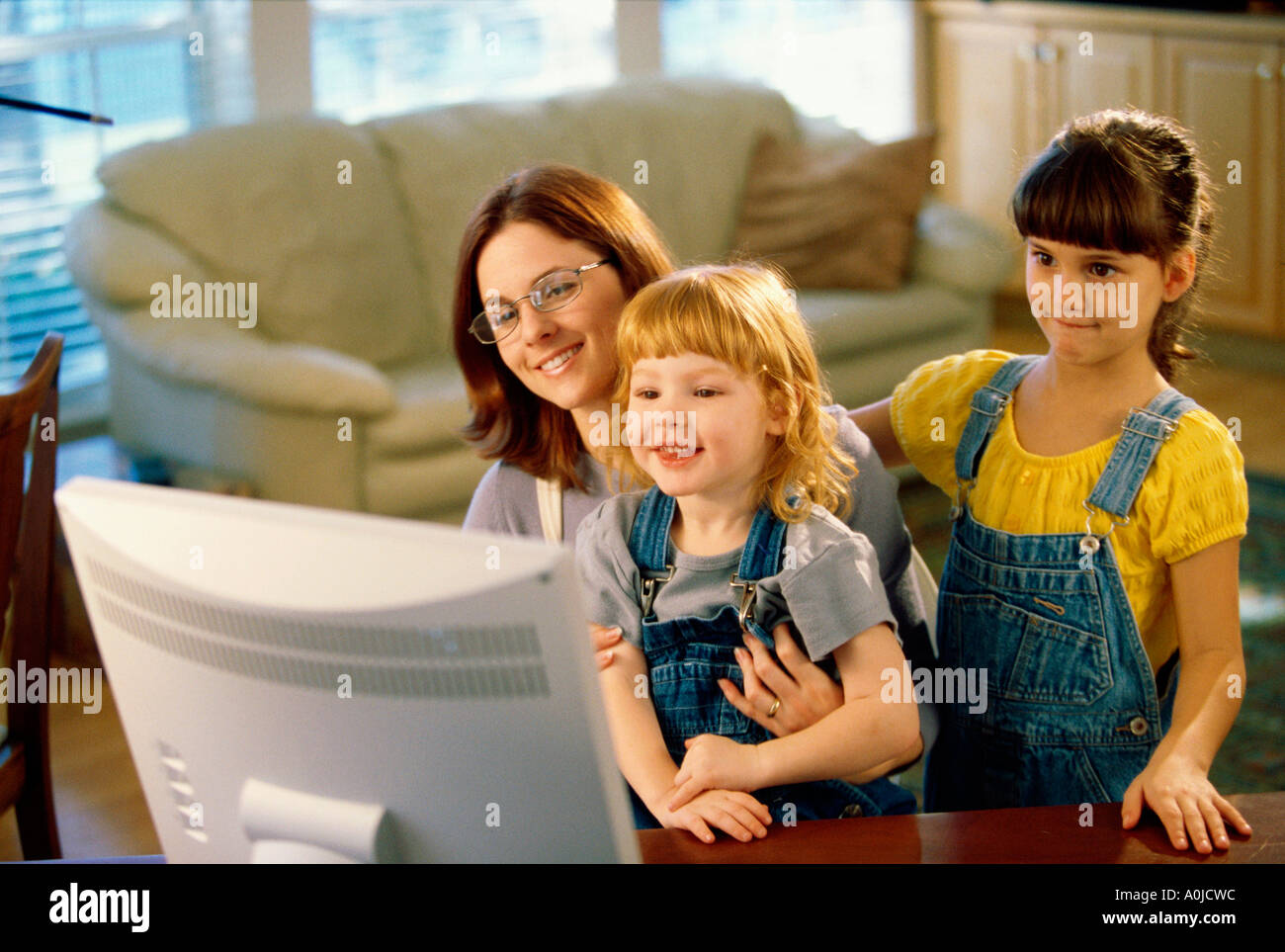 Three girls looking computer monitor hi-res stock photography and ...