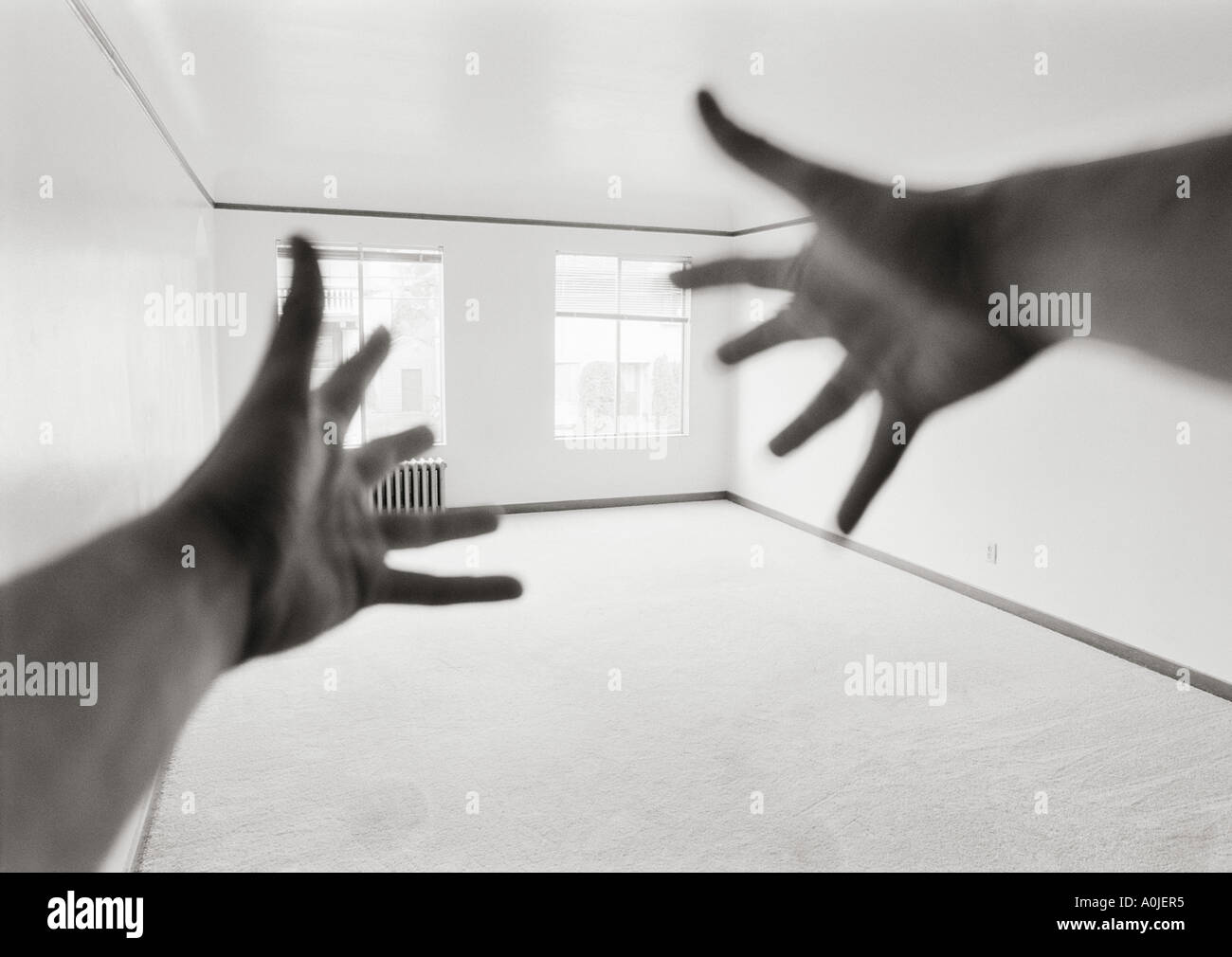 Hands reaching across an empty room Stock Photo - Alamy
