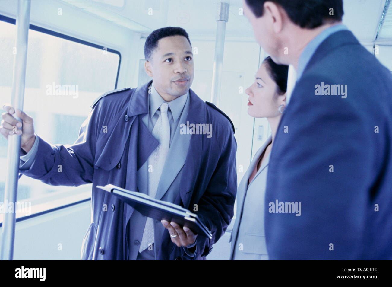 Business executives talking to each other in a subway train Stock Photo ...